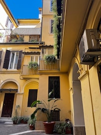 Huge wooden doors open to interior courtyards. Proceed to this main courtyard for the hotel entrance.