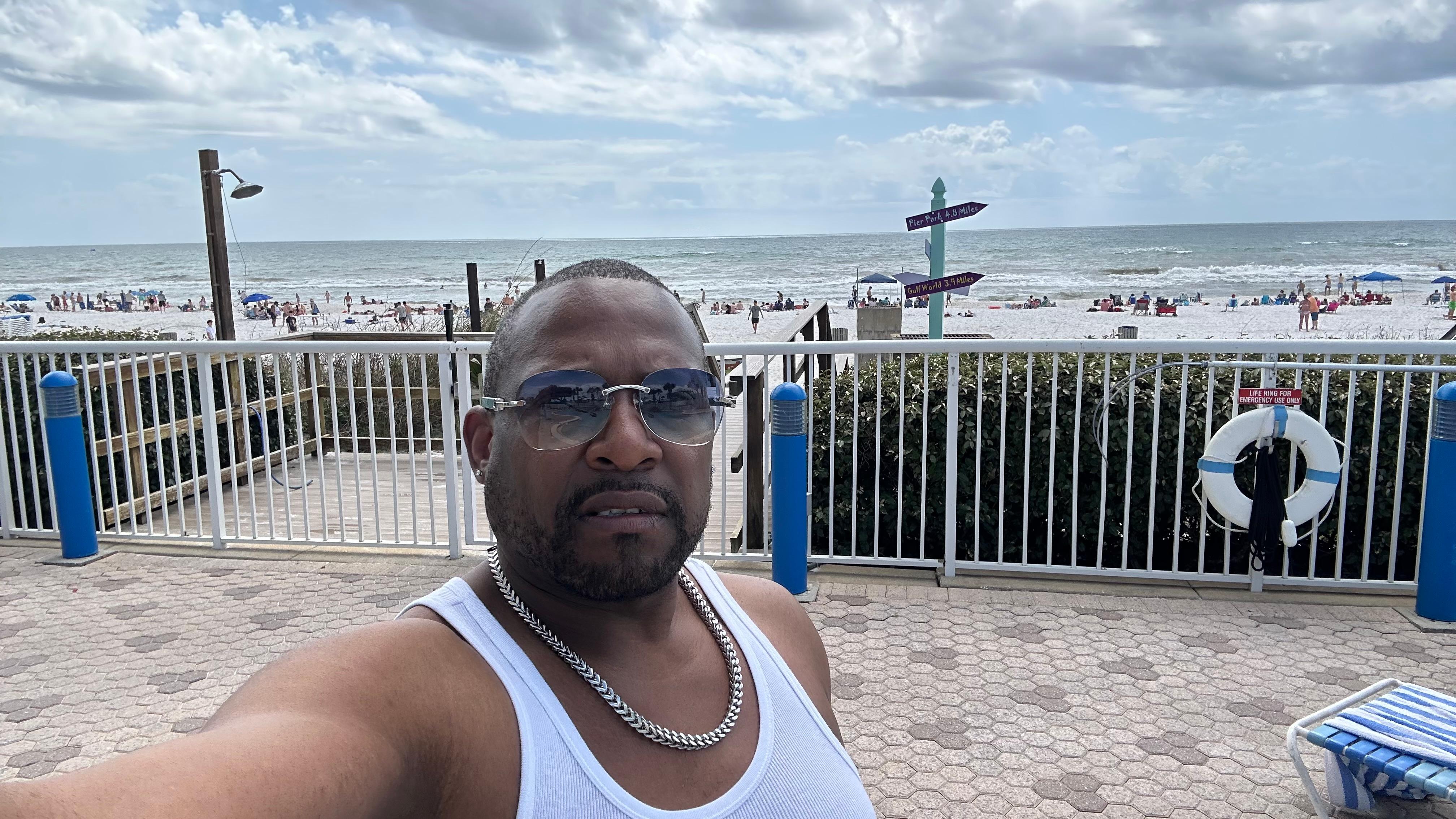 Outside at the pool with beach view behind me 