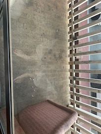 Cigarette buts at sliding door.