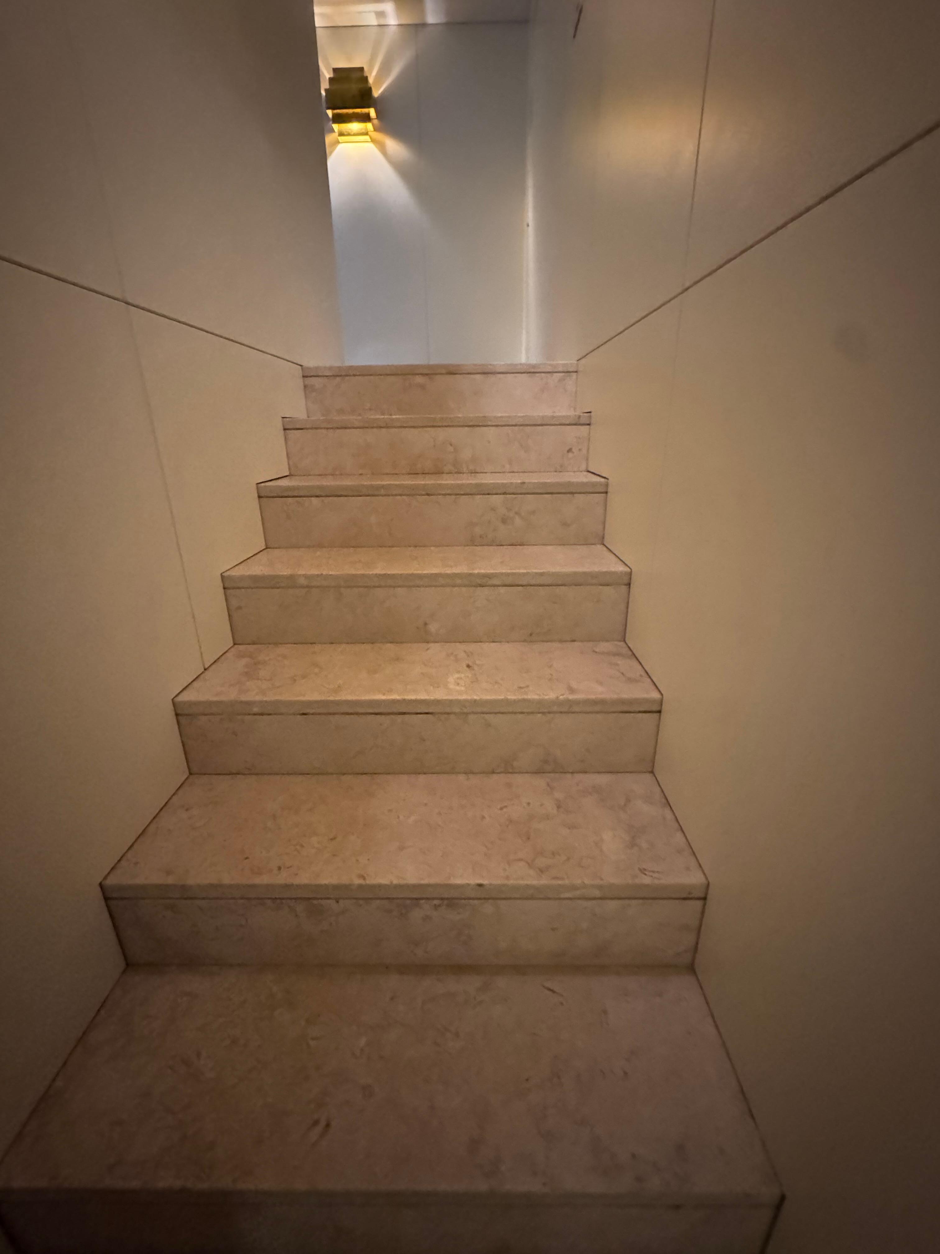 Staircase leading to upstairs sitting area and sleeping area