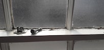 Broken window catch in shower room