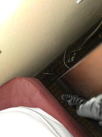 Lollipop stick behind bed stand.