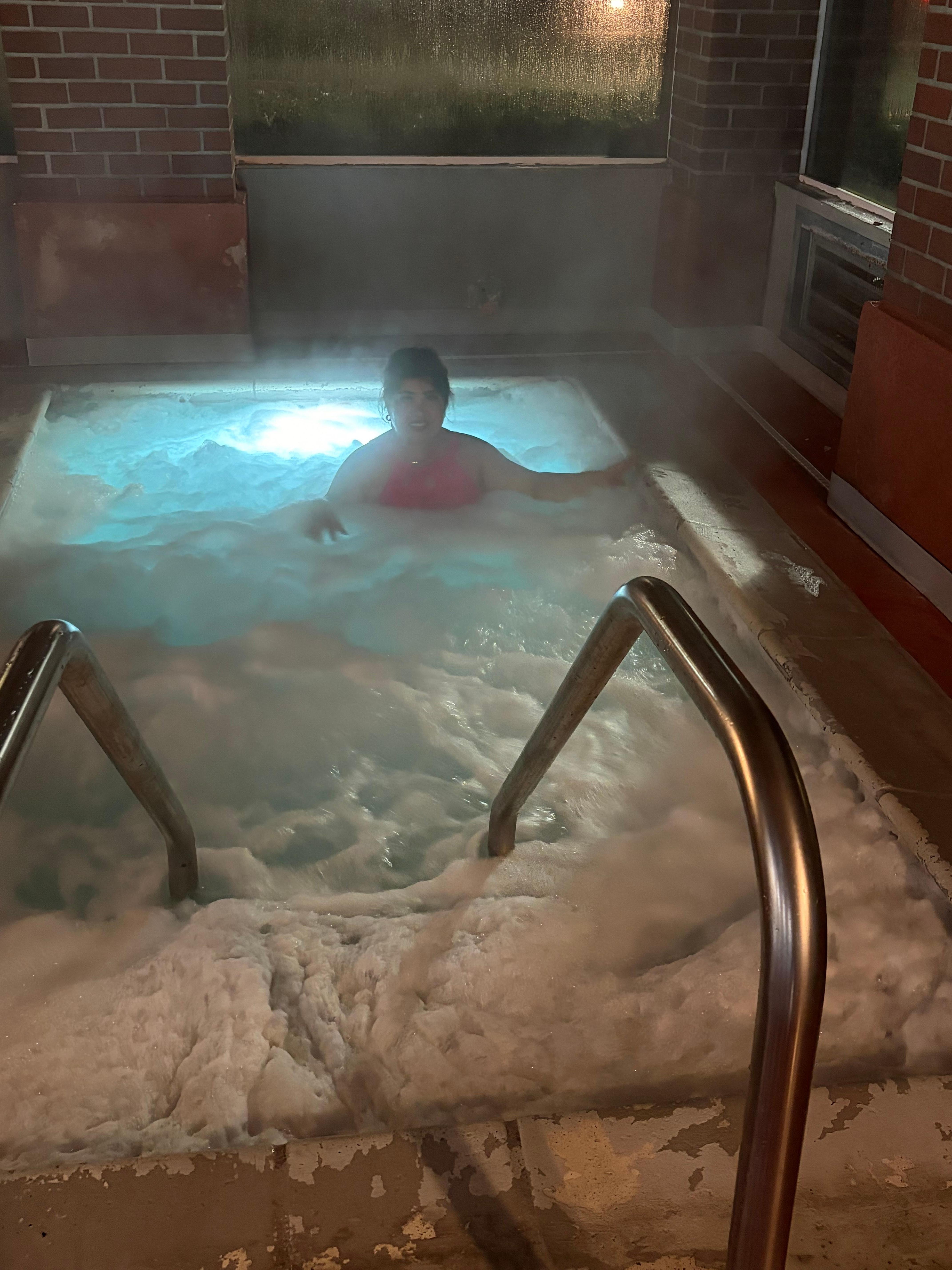 Hot tub indoor next to pool 