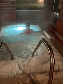 Hot tub indoor next to pool