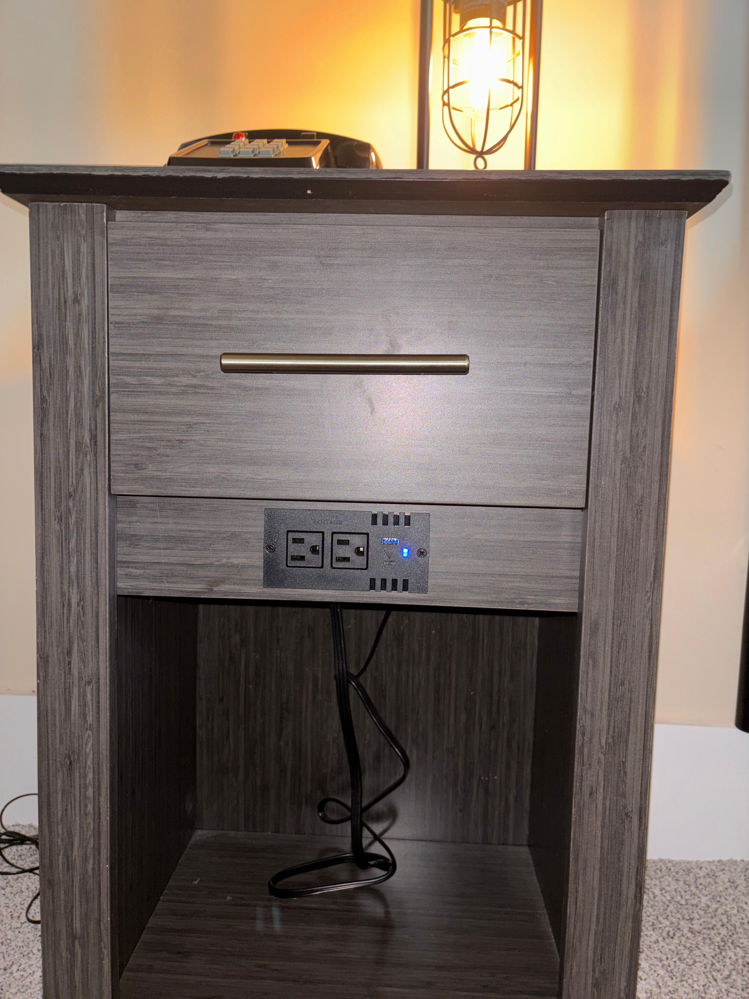 Charging connections on both bedside nightstands and also on lamp base.