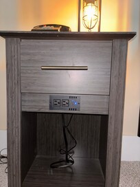 Charging connections on both bedside nightstands and also on lamp base.