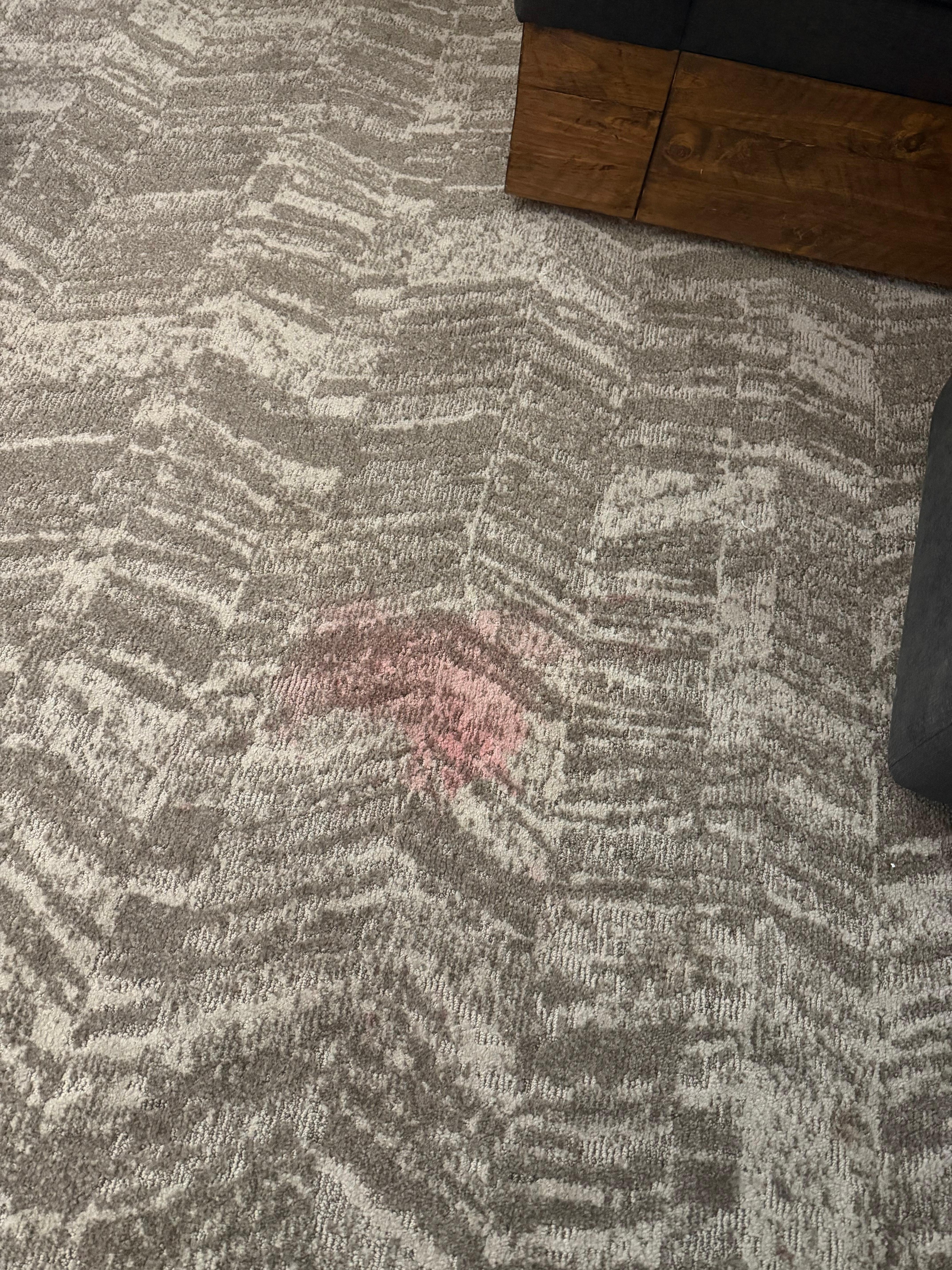 1 of the 4 red spots in the carpet