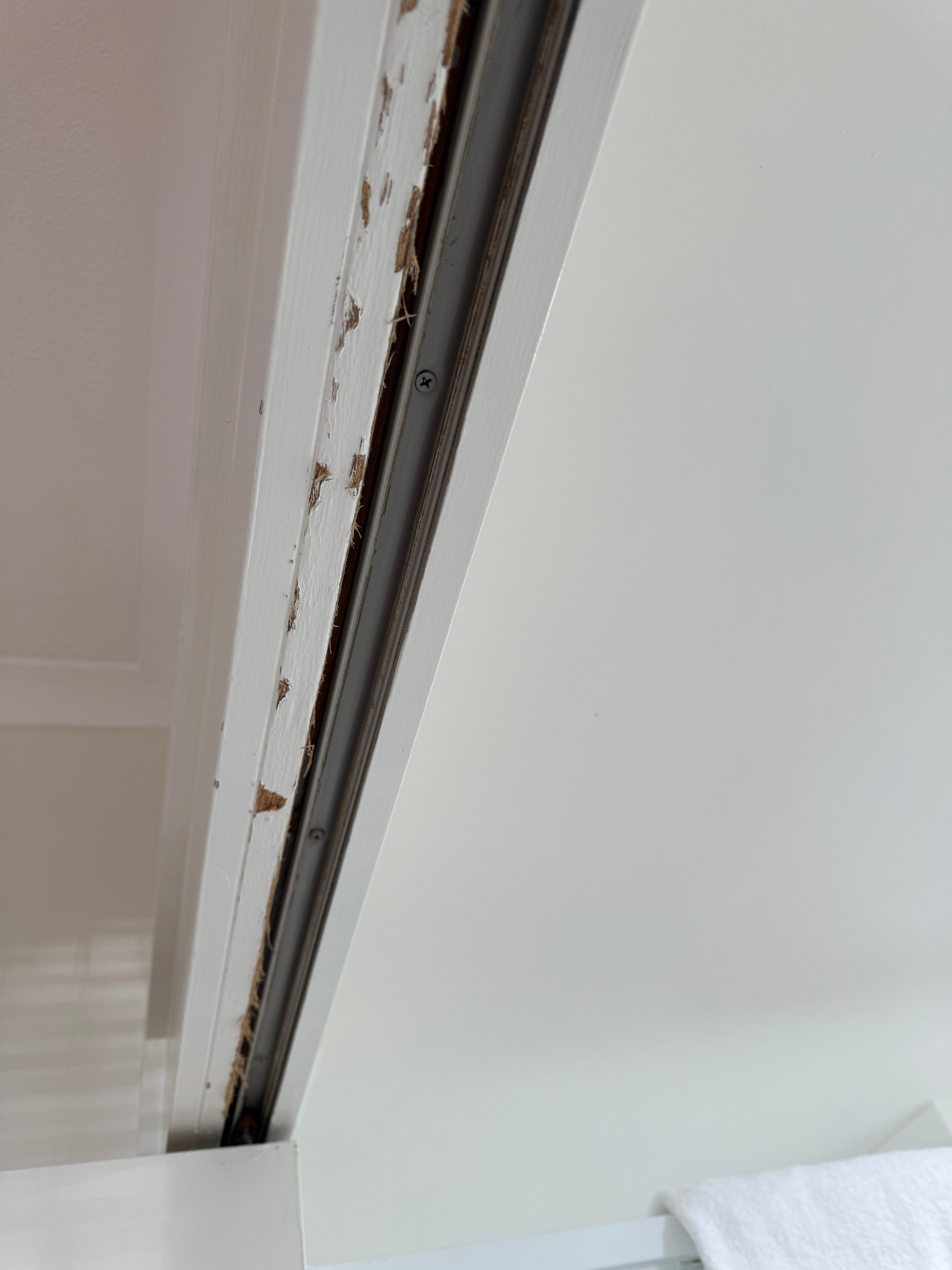 The state of the door frame between the bedroom and the bathroom. I am only allowed 8 photos. I have about 25-26. Chipped furniture, rusted lamps, broken sliding dividers. 