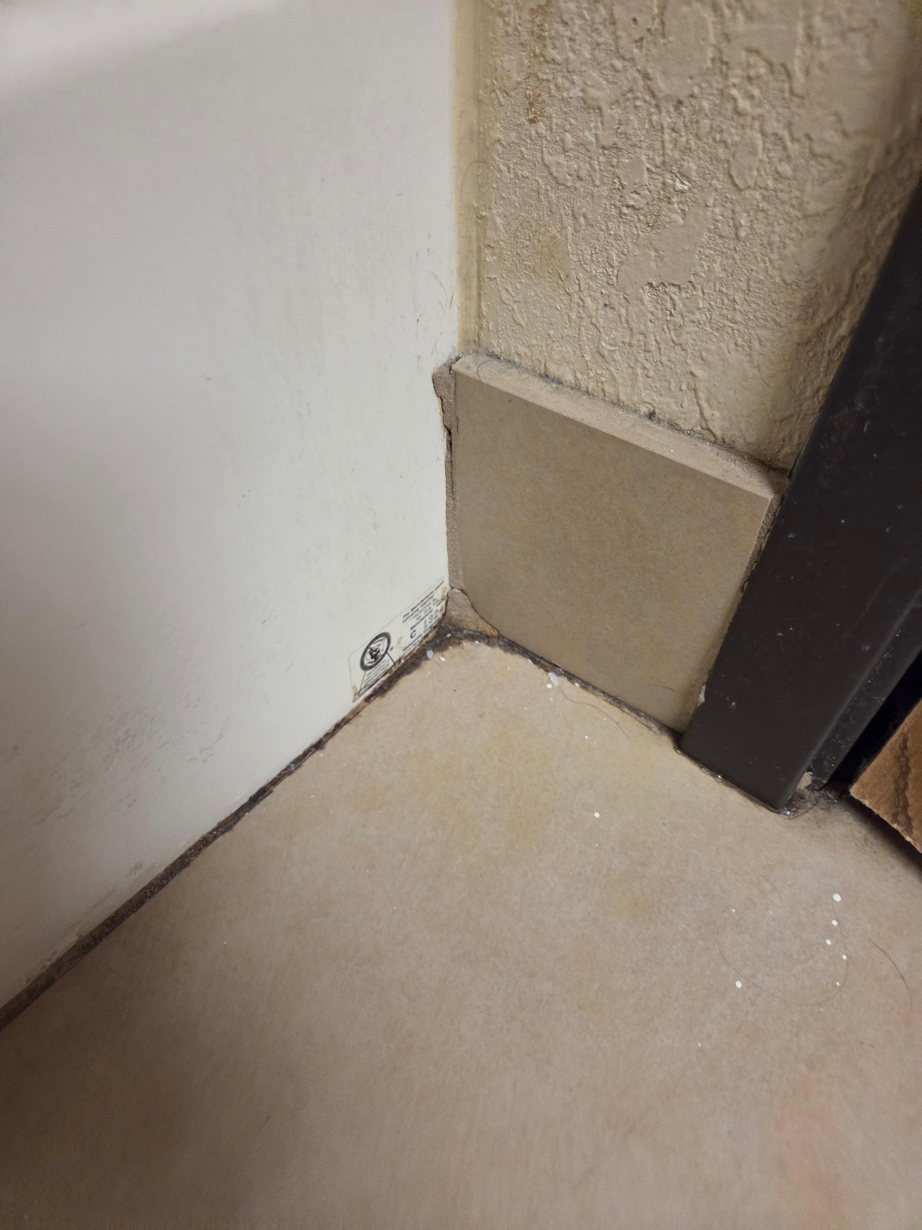 Dirt or mold in the corner at the tub, wall and floor.