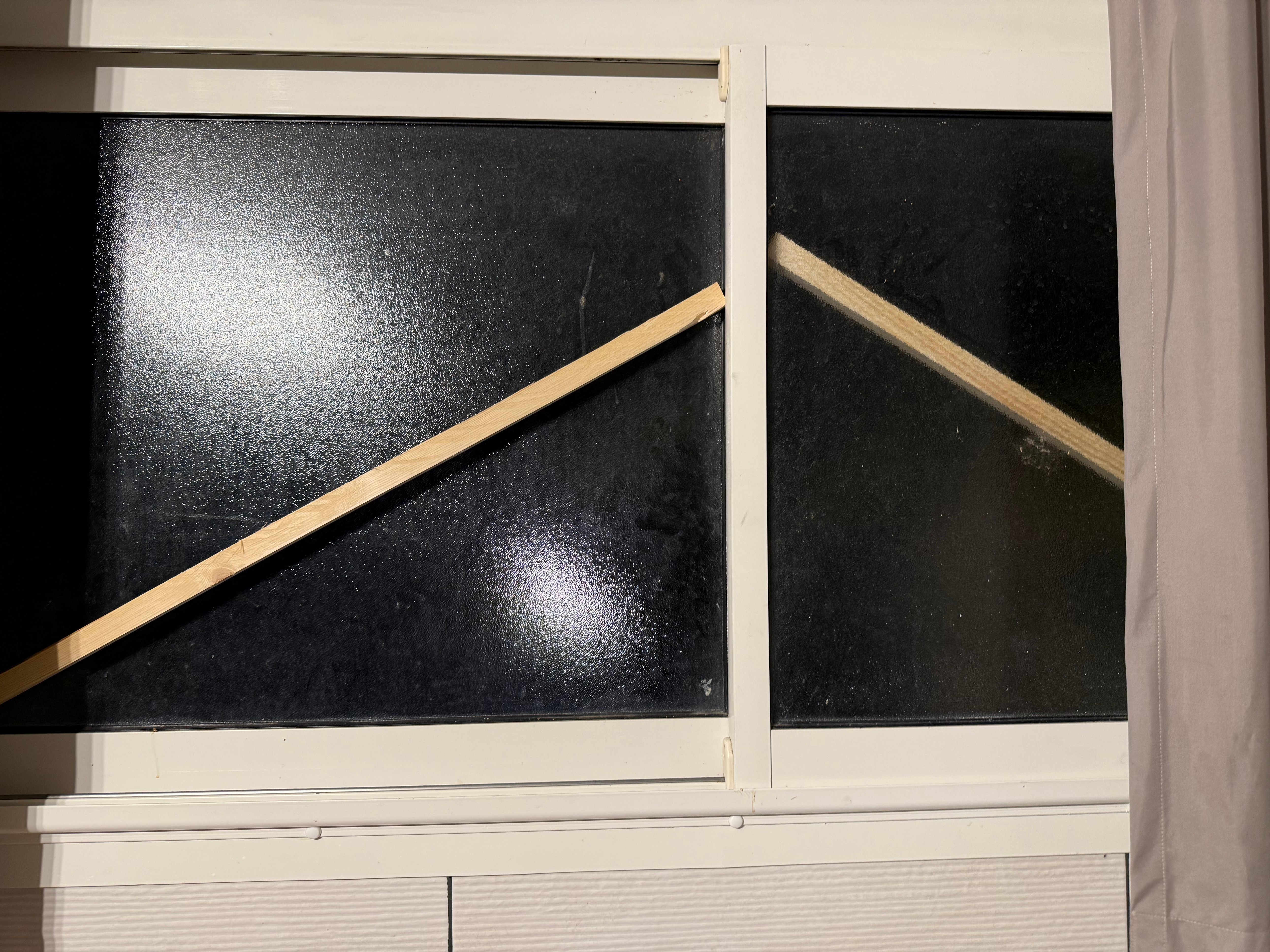 Fermeture fenêtre assurée par des morceaux de bois 