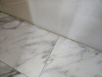 All flooring is peel and stick fake tiles that come up when stepped on