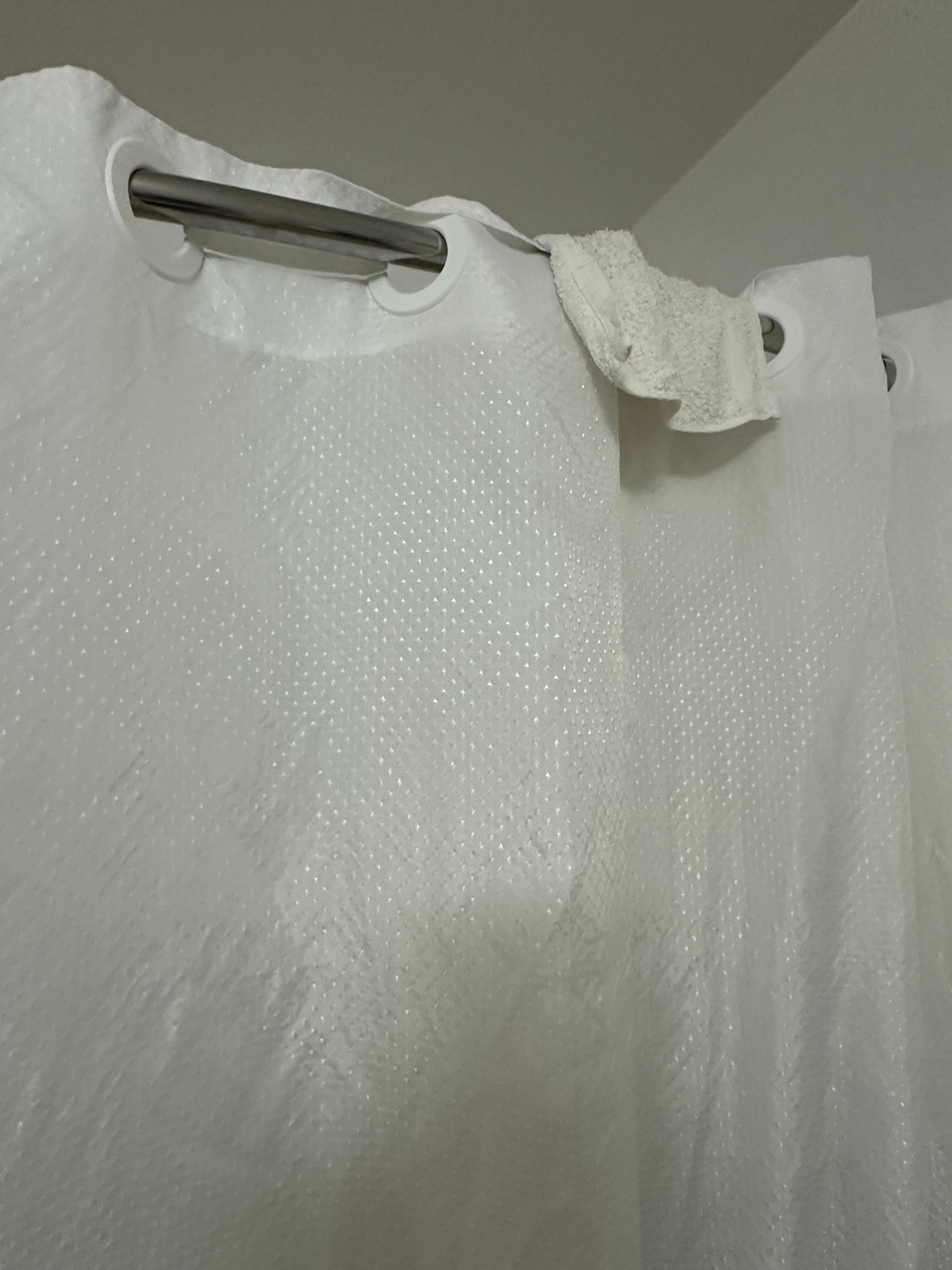 Old dried washcloth hanging on shower