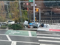 Directly across the street, trash piled to the guardrails.