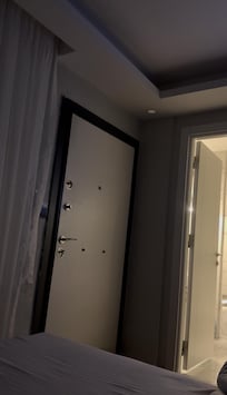 The sound of heavy rain on the floor in front of the door