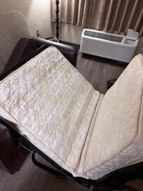 The soiled mattress of the sofa bed. Sheets cost extra.