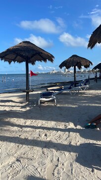 Sunbeds on small beach as well as by pool