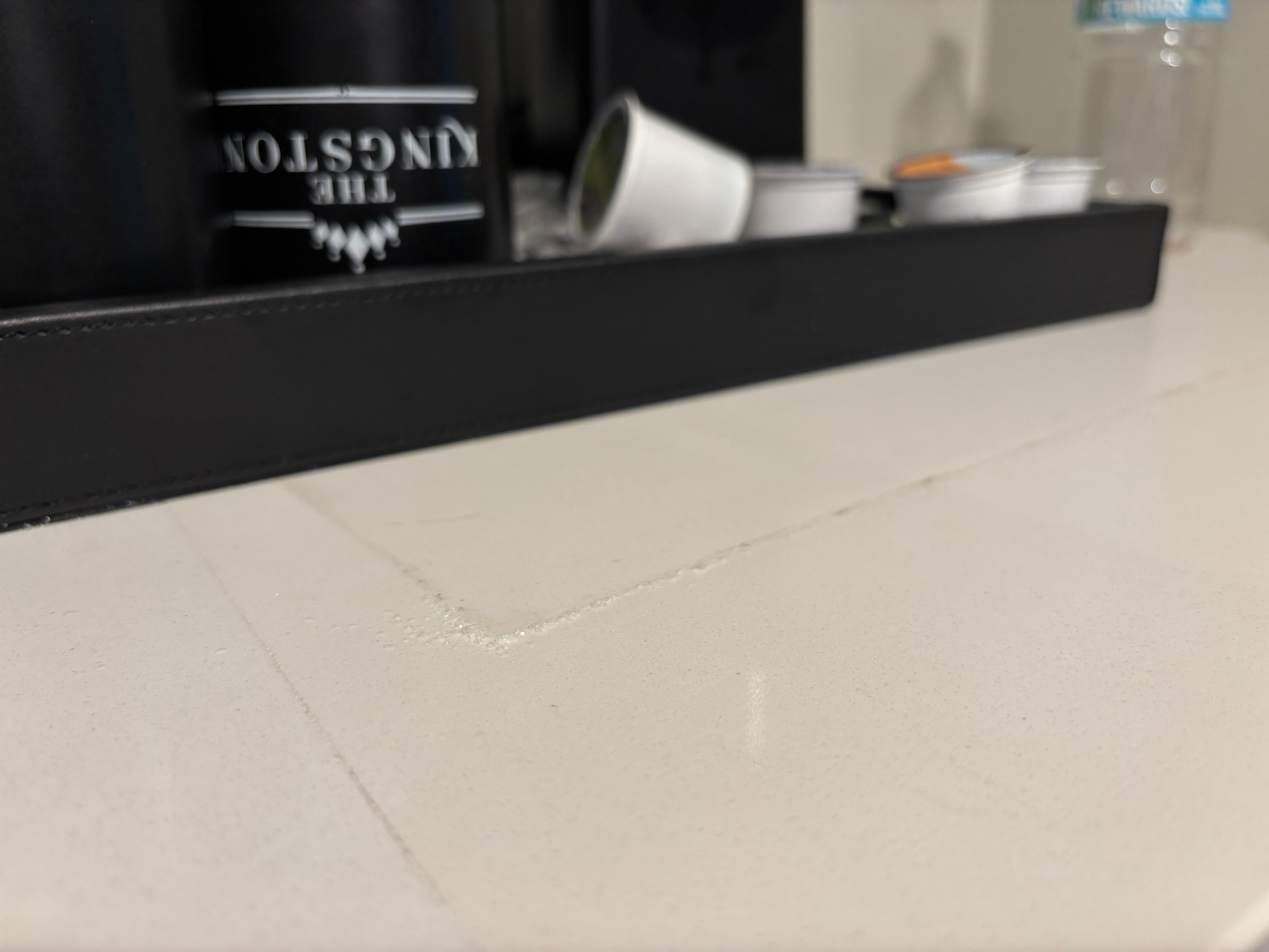 The line of sugar left by previous guests that housekeeping never cleaned, and therefore literally glued the tray to the surface