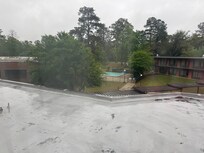 View of abandoned part of hotel rotting roof and unsafe walkway and closed pool