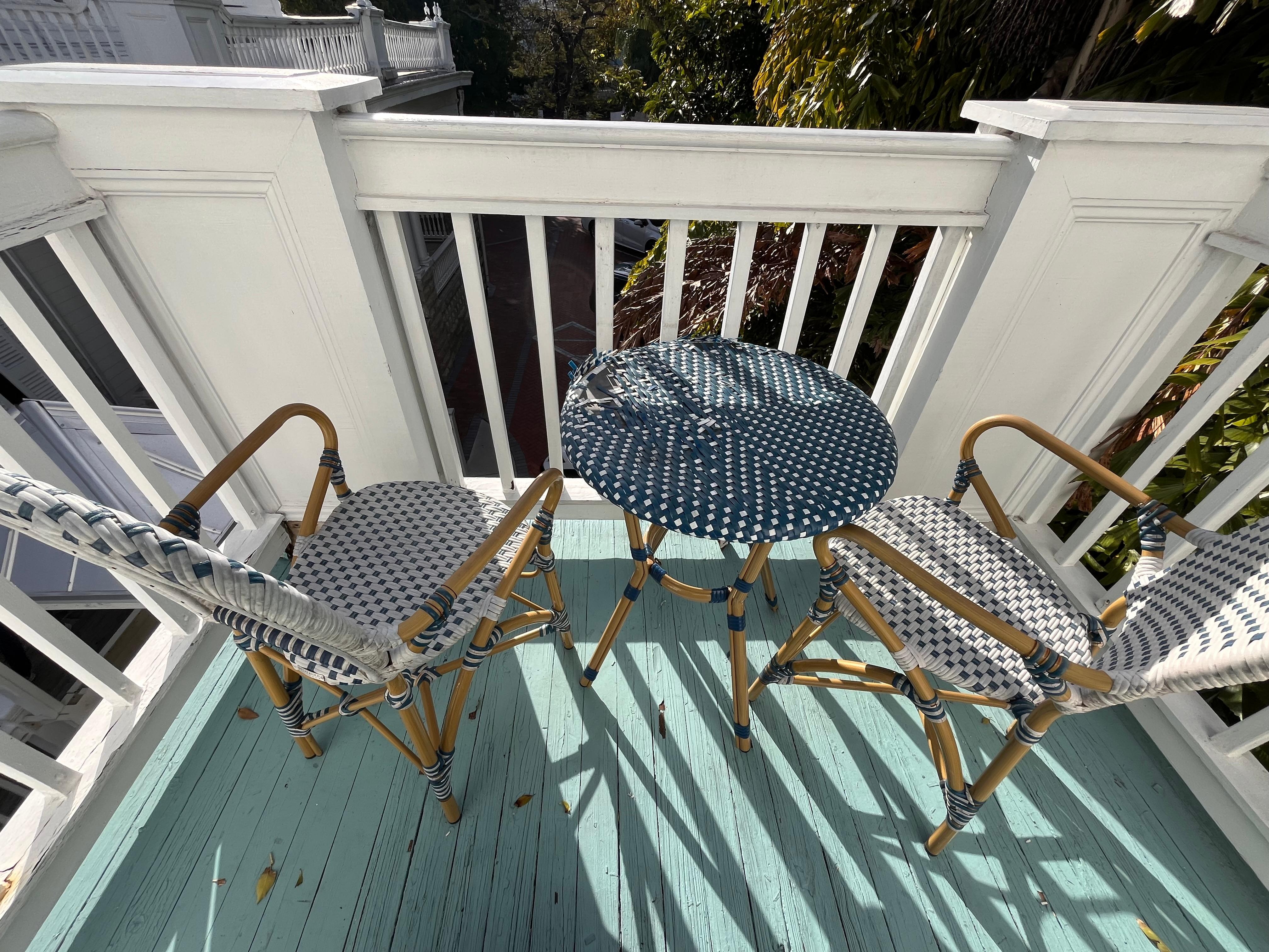 Small balcony with small chairs. 