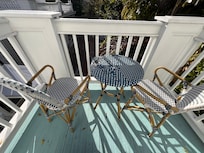 Small balcony with small chairs.