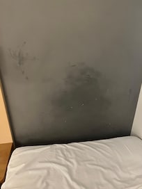 Filthy walls where headboard should have been. Mattresses slanted upward and sideways towards walls so no avoiding dirt