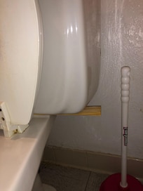 This toilet has a broken wax seal and the tank seal was missing. Hence the wood.