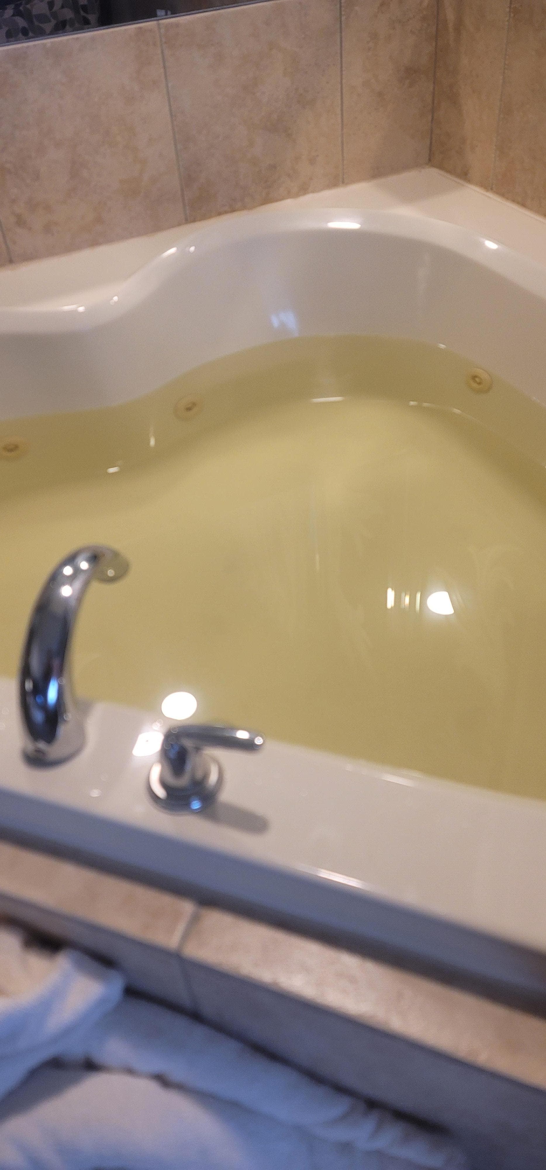 This is what the water in jacuzzi looked like after running the water for a long time and after several attempts 2 days In a row.  It was much more yellow the first time but never actually got better.