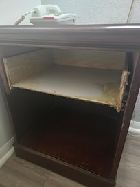 This is the night stand next to the bed, and the drawer was broken off of the front. Trash.