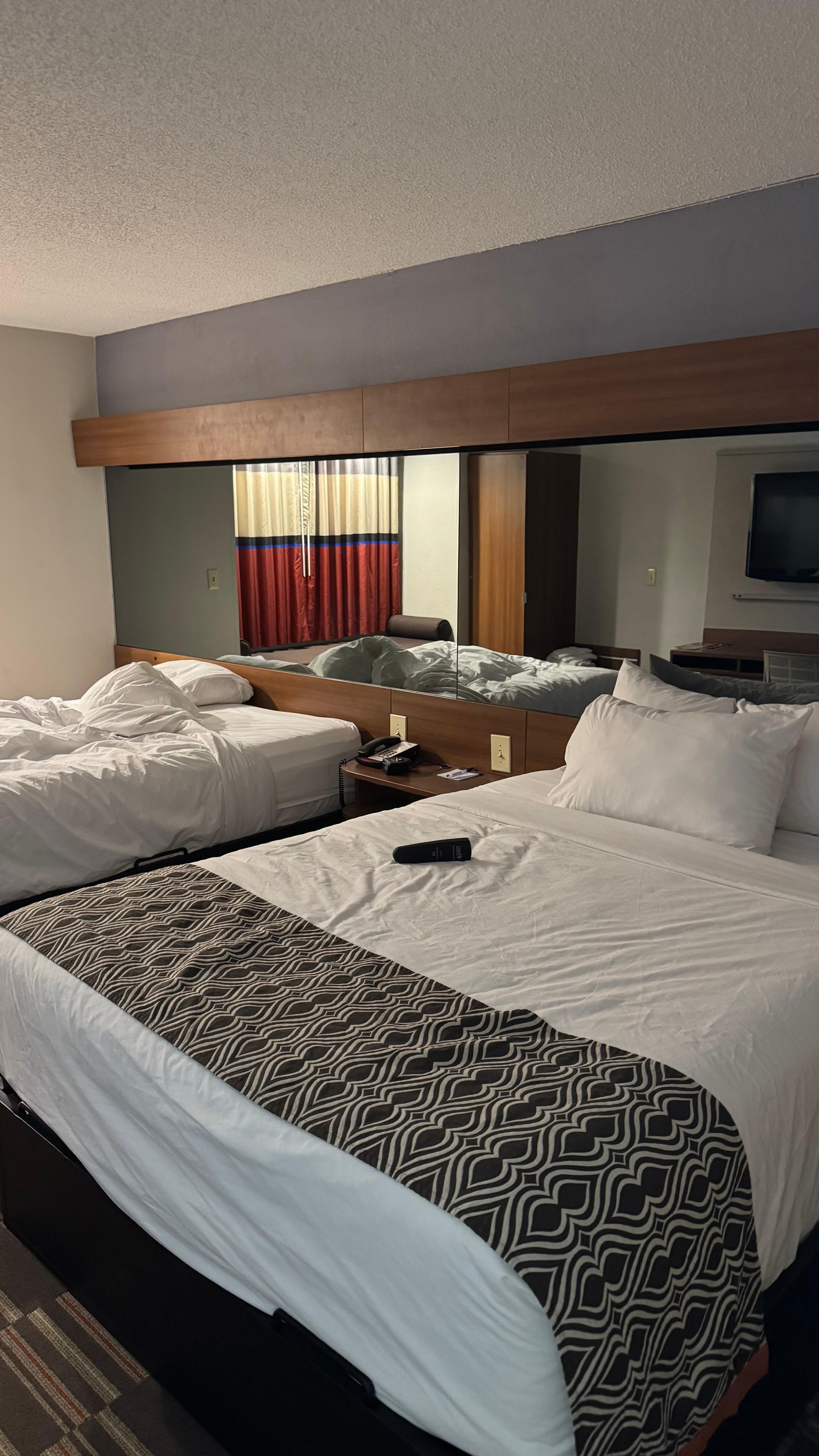 Creepy giant mirror behind the beds.