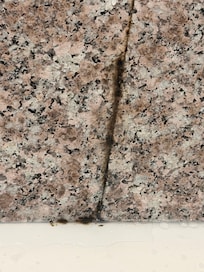 Heavy mildew accumulation in and around tub.