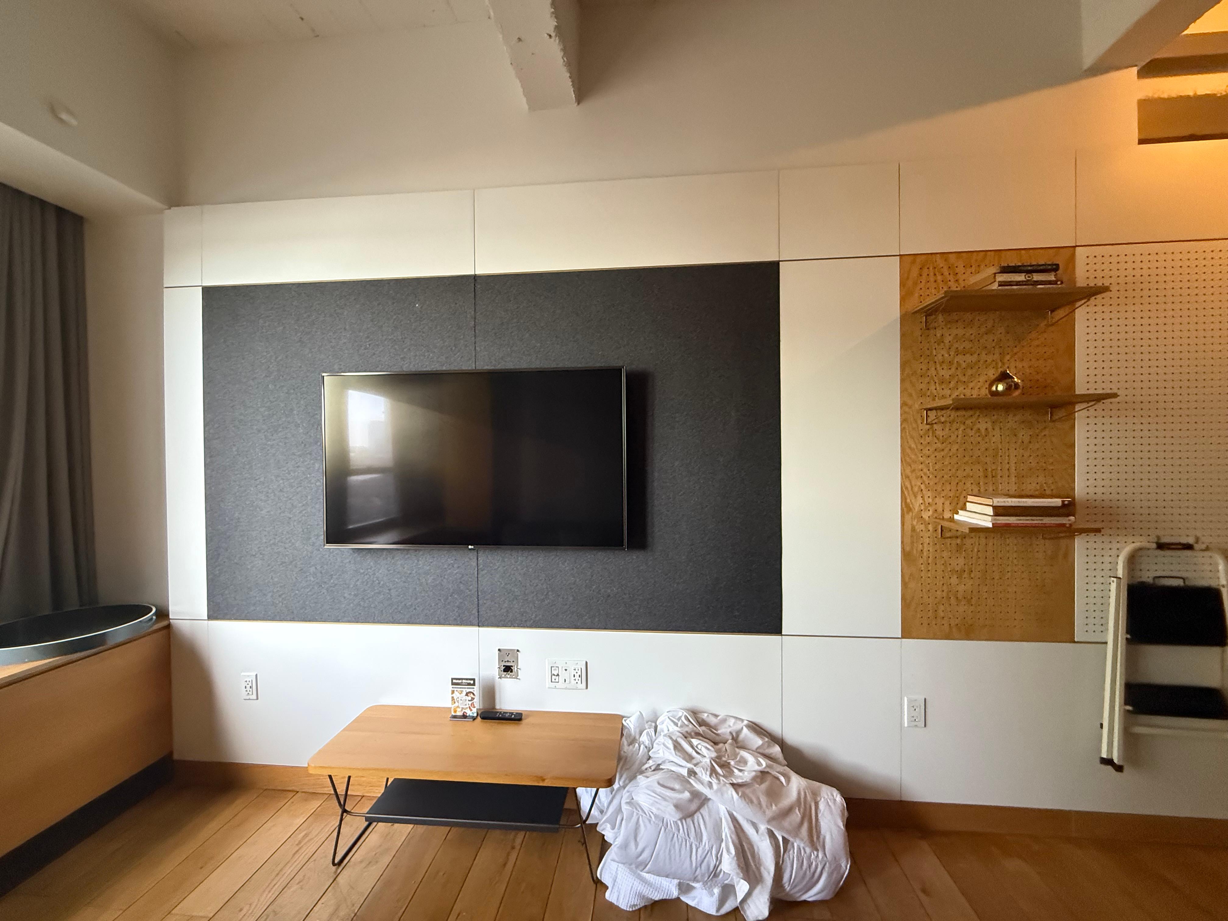 TV with small table, shelf under the window, and wall shelves. (And our dirty sheets-I took these when we were leaving.)