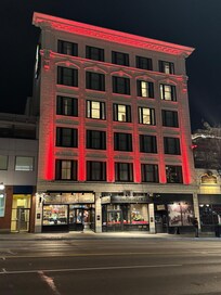 Outside hotel on a Main Street. Hotel has a pub and liquor store attached.