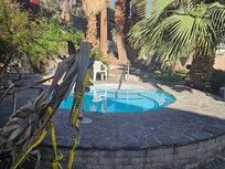 Hot tub area with overgrown landscaping