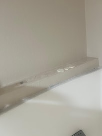 Random pieces of bar soap and dirt in the shower