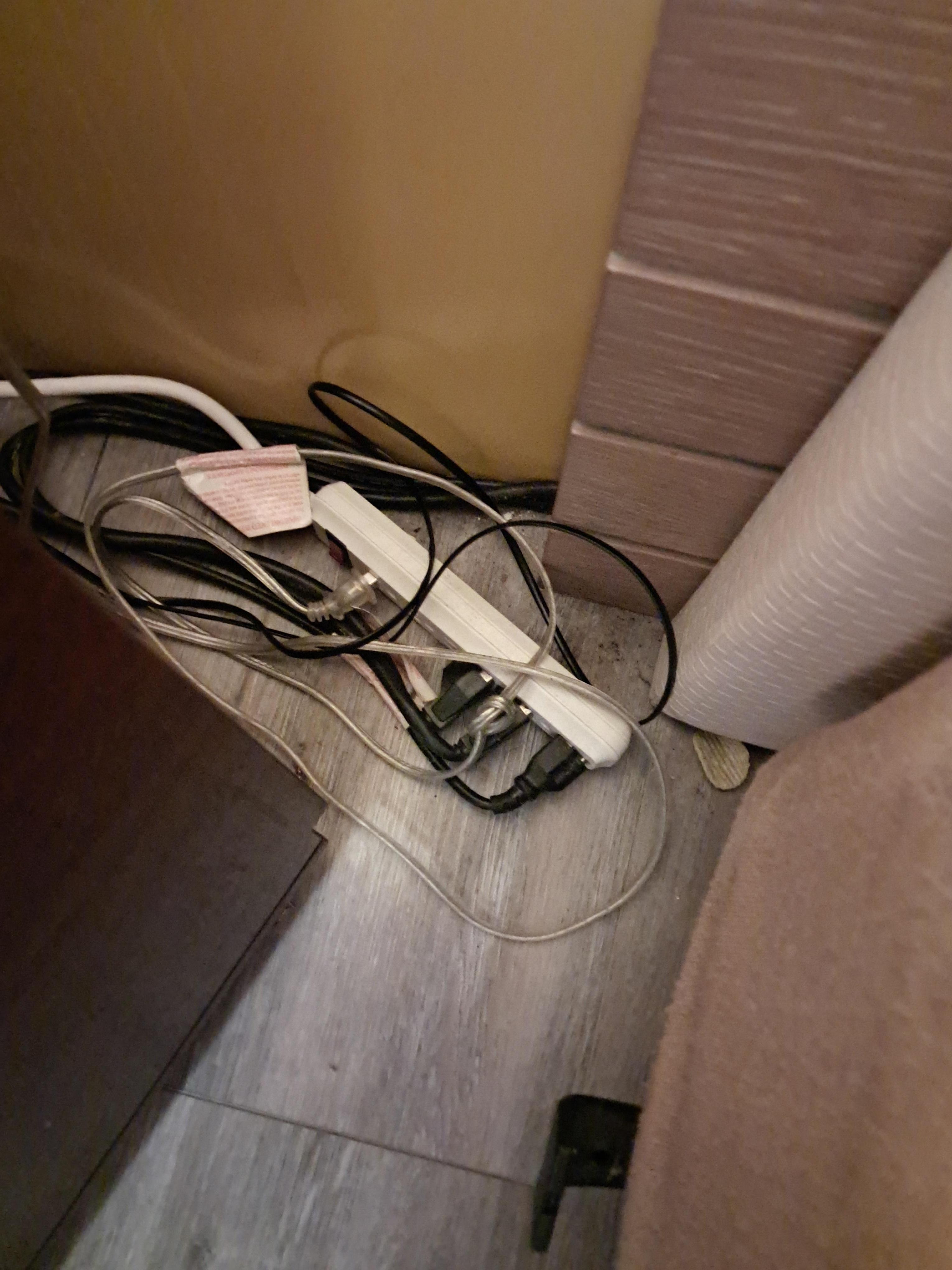 Unsafe power source behind night stand