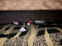 Trash stowed next to the bed from a previous day