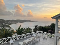 View of the downstairs patio and pool area and the bay.