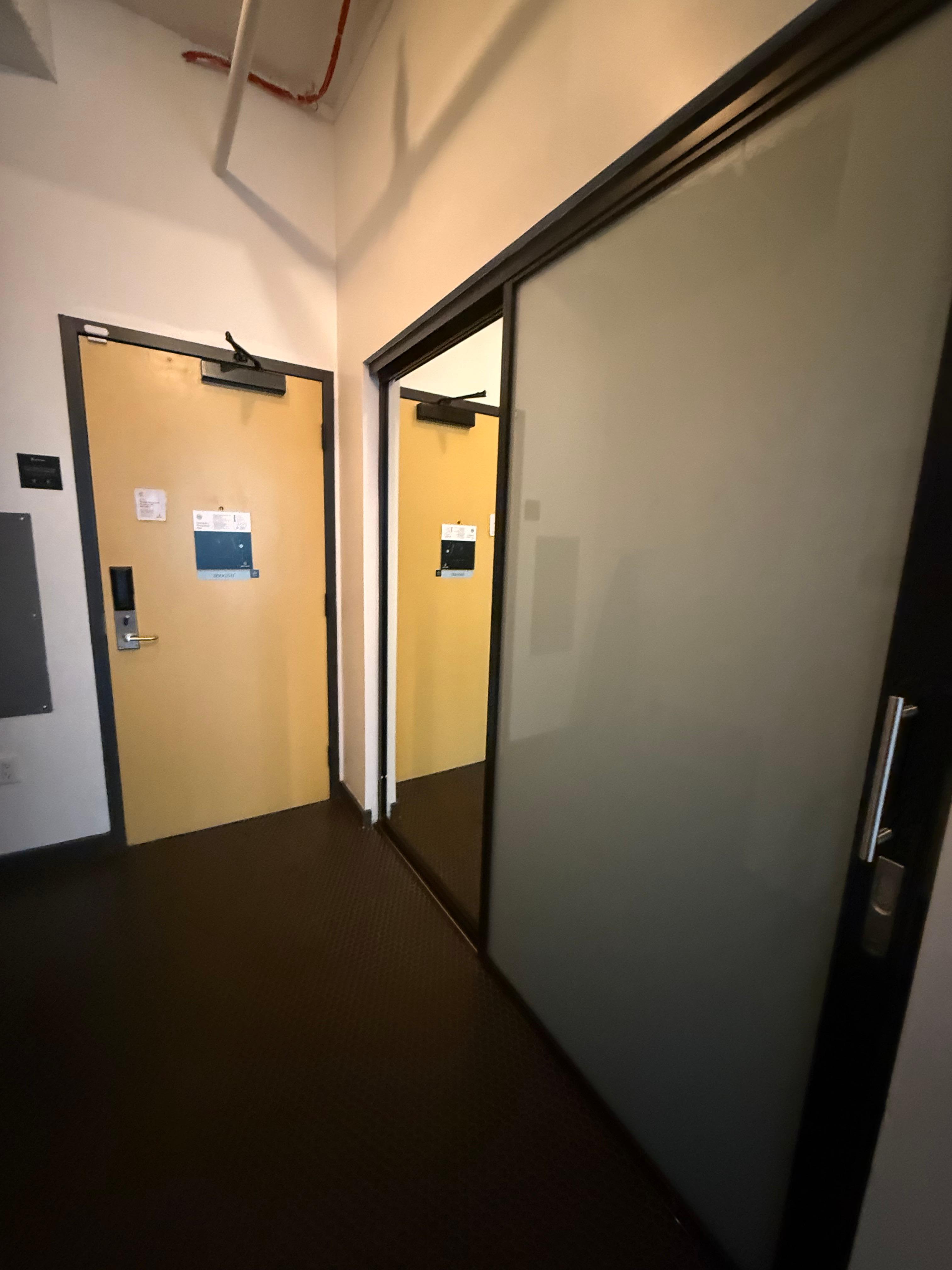 Front door with bathroom sliding door, and full length mirror.