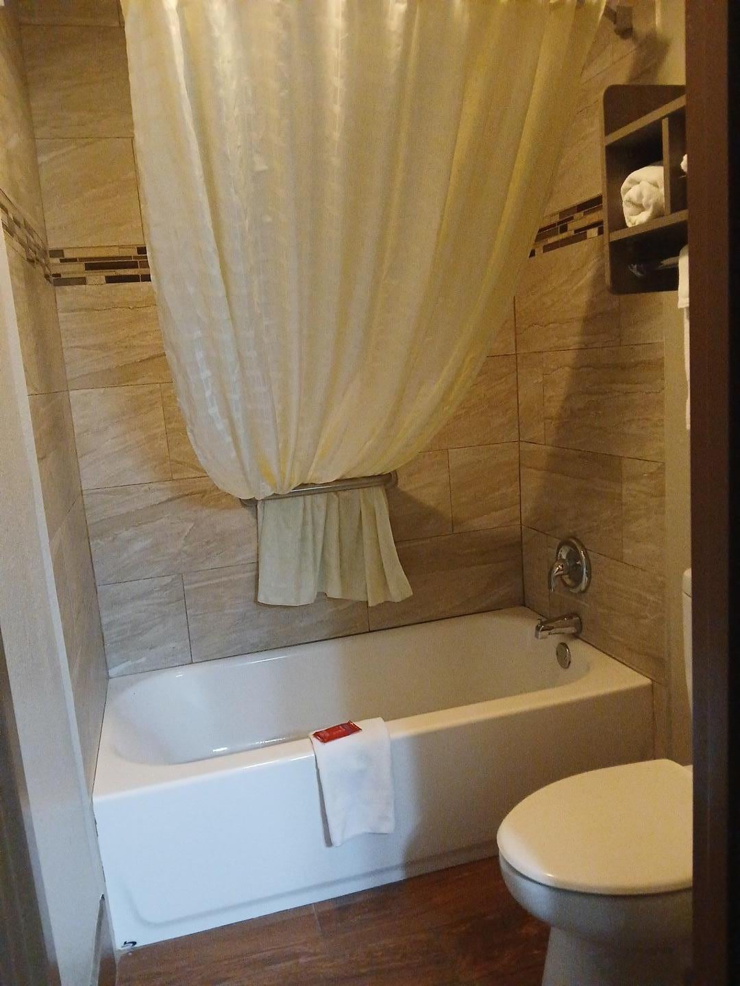 You'll definitely want to take advantage of this. Water at a perfect temperature in no time without waiting 20 minutes for it to heat up plus a shower head that actually works! They use the curved shower rod so the curtain doesn't touch you.