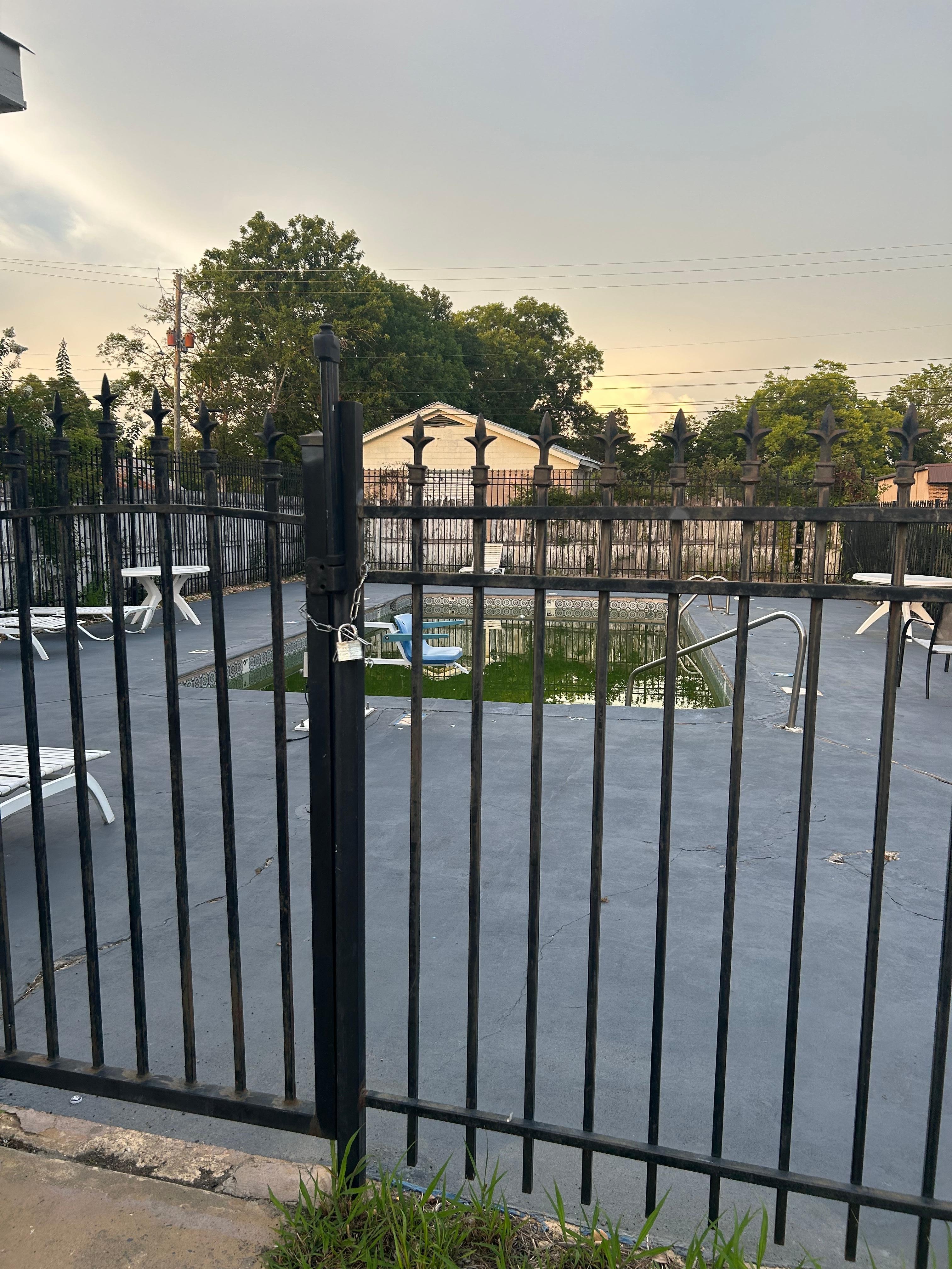 Pool locked with pad lock and chain. Water is green. Manager says they don't use the pool/