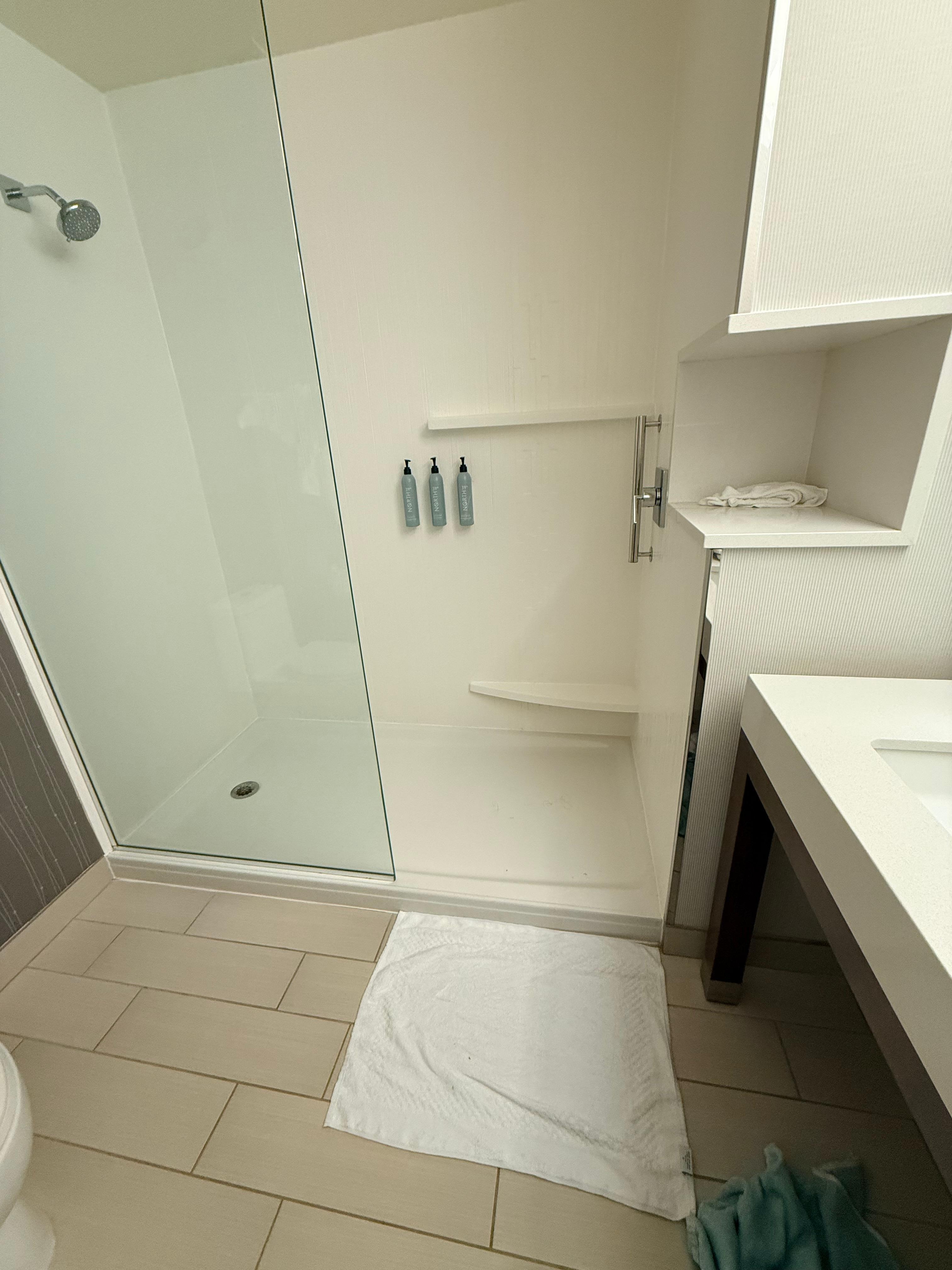 Half shower wall that does not block the water from soaking the floor creating an extremely slippery surface to step out of shower on. As you can see there aren’t any anti slip coated strips or anti slip rubber mats in or outside of the shower. 