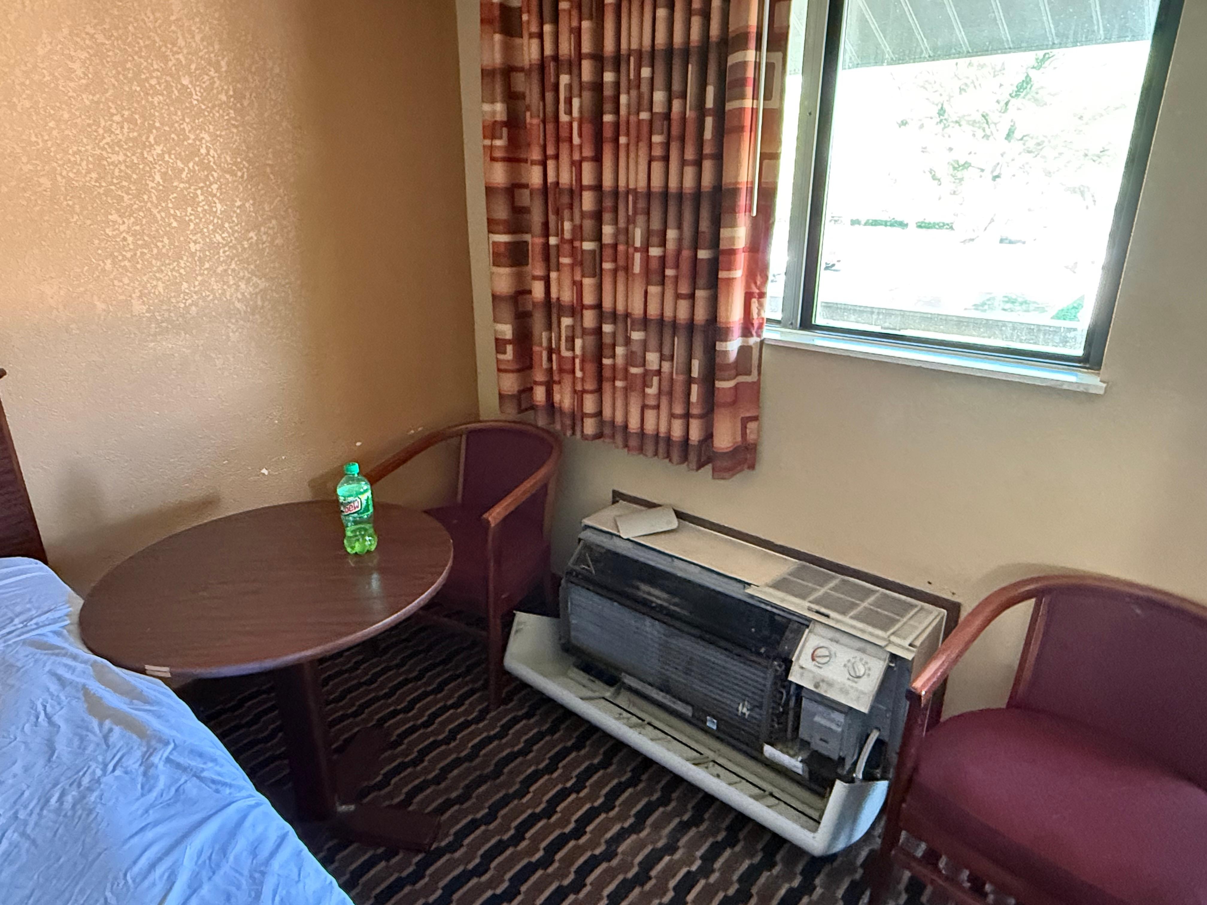 Opened Mt.Dew on table. Heating and Cooling unit ripped off wall on floor.