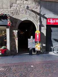 The entrance can be found down this entry. The stairs are on the left, through the gate before the Restaurant