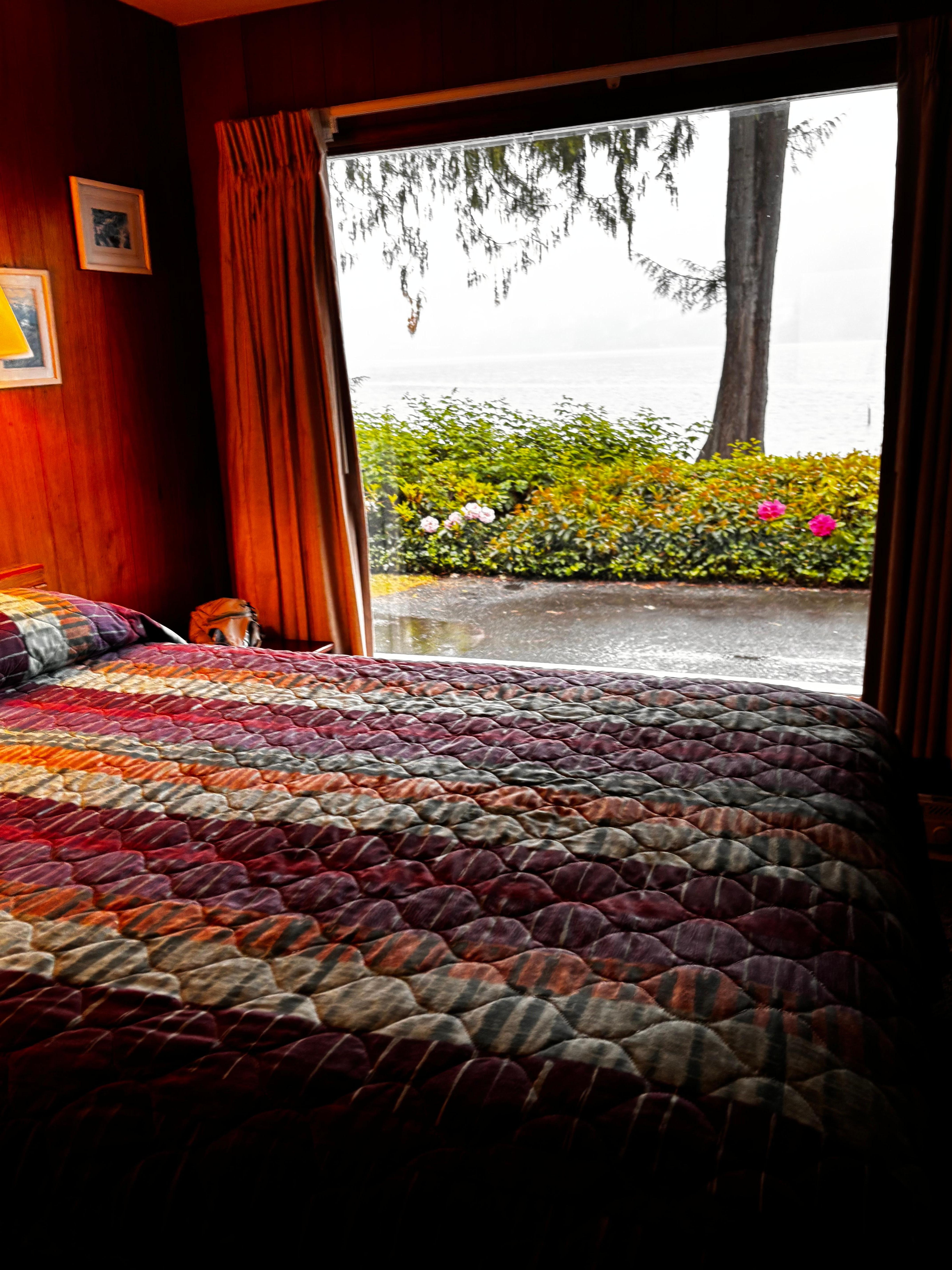 Q bed and large window in other room.