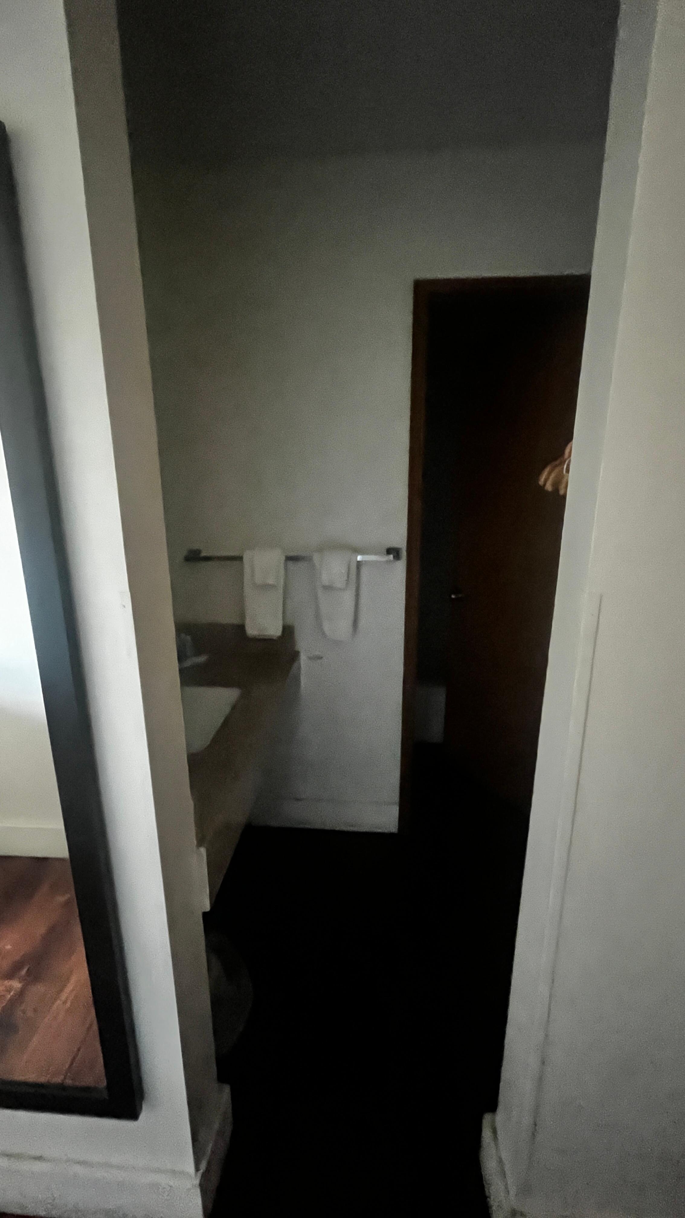 Another view of the gross and tiny bathroom. Good luck turning around in here.