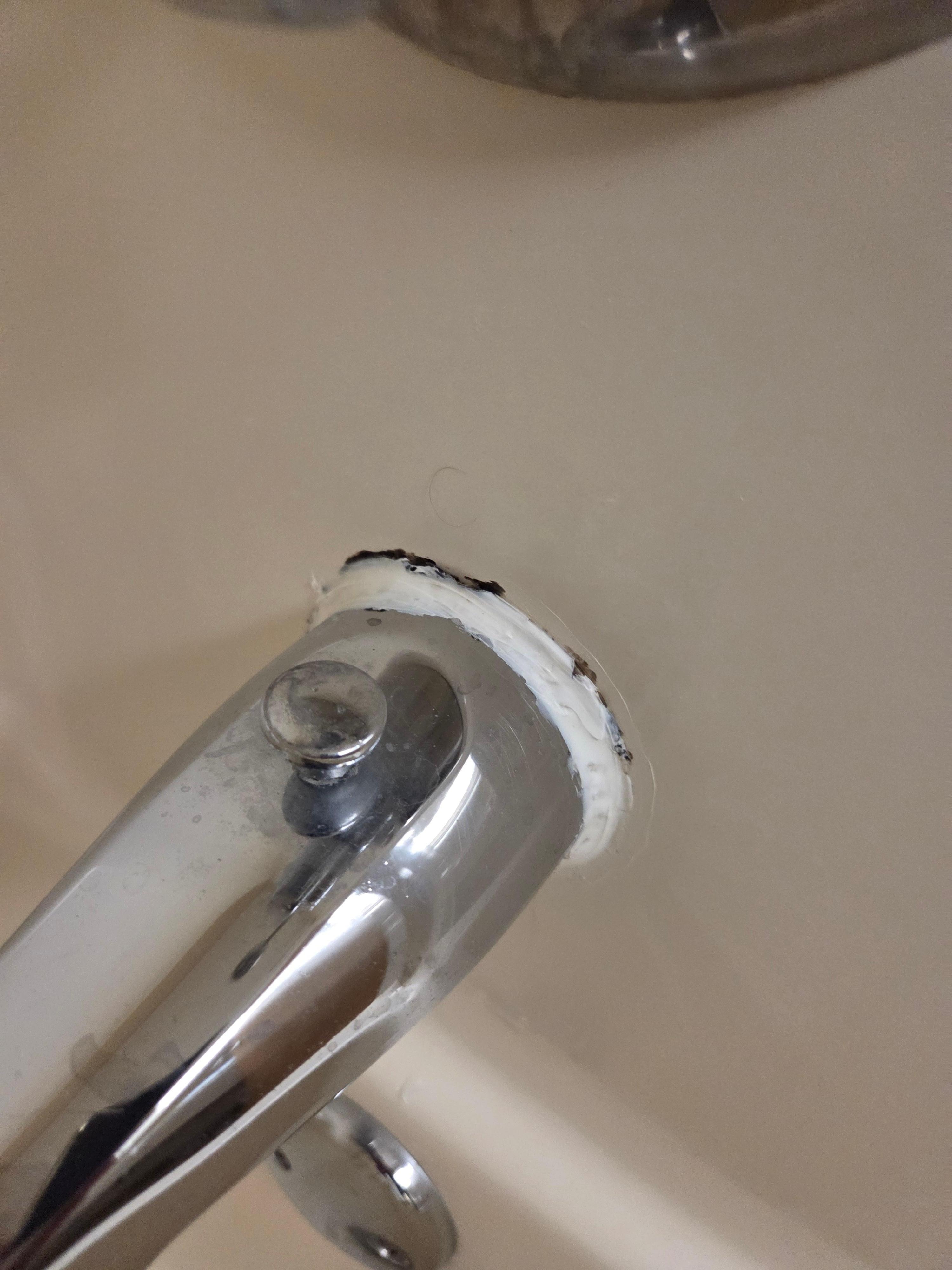 Looks like mold on caulk around the tub faucet.