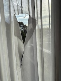 Torn net curtain.