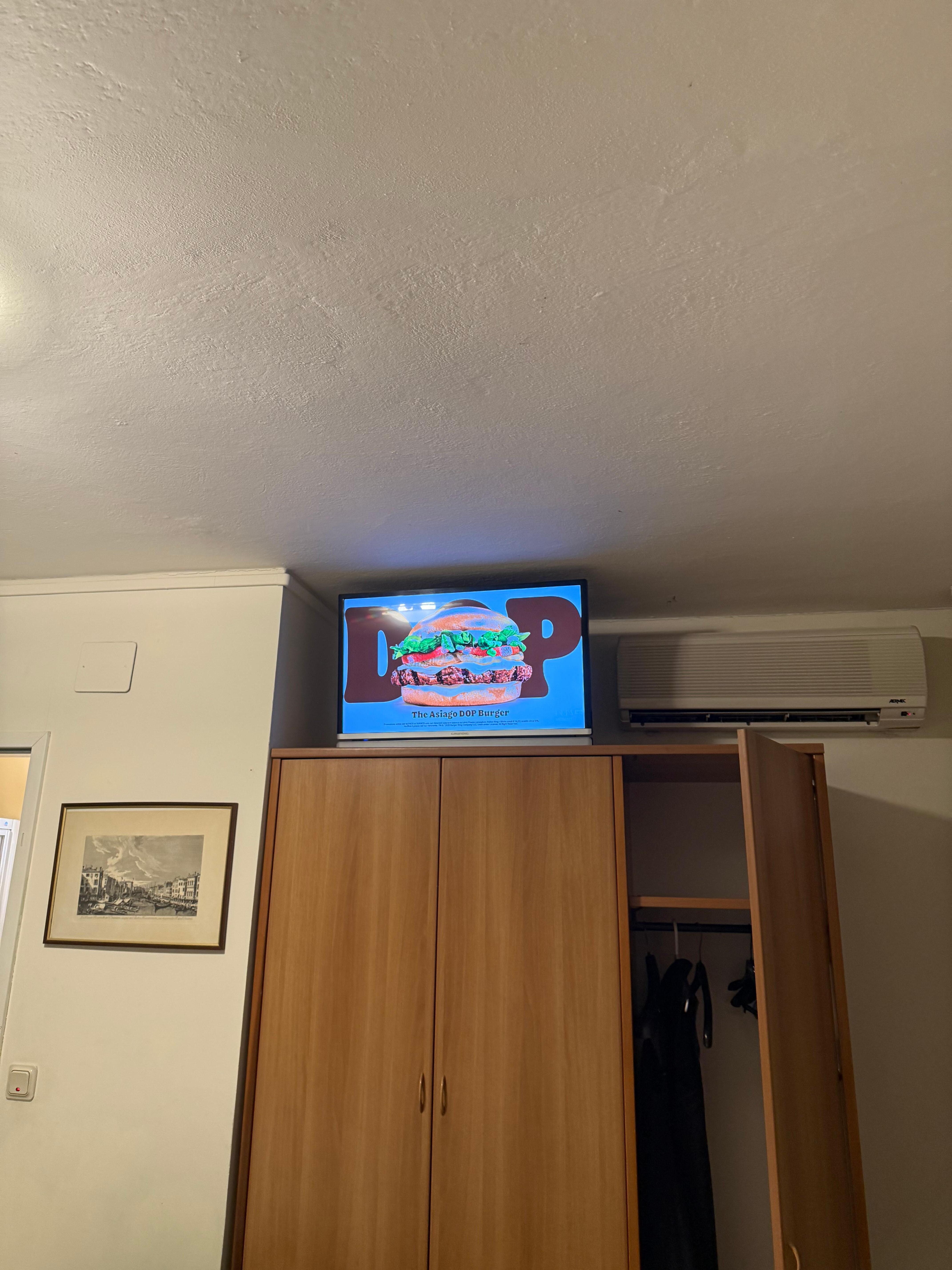 Never seen a tiny tv on a weird wardrobe with hangers that came from a flea market 