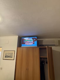 Never seen a tiny tv on a weird wardrobe with hangers that came from a flea market