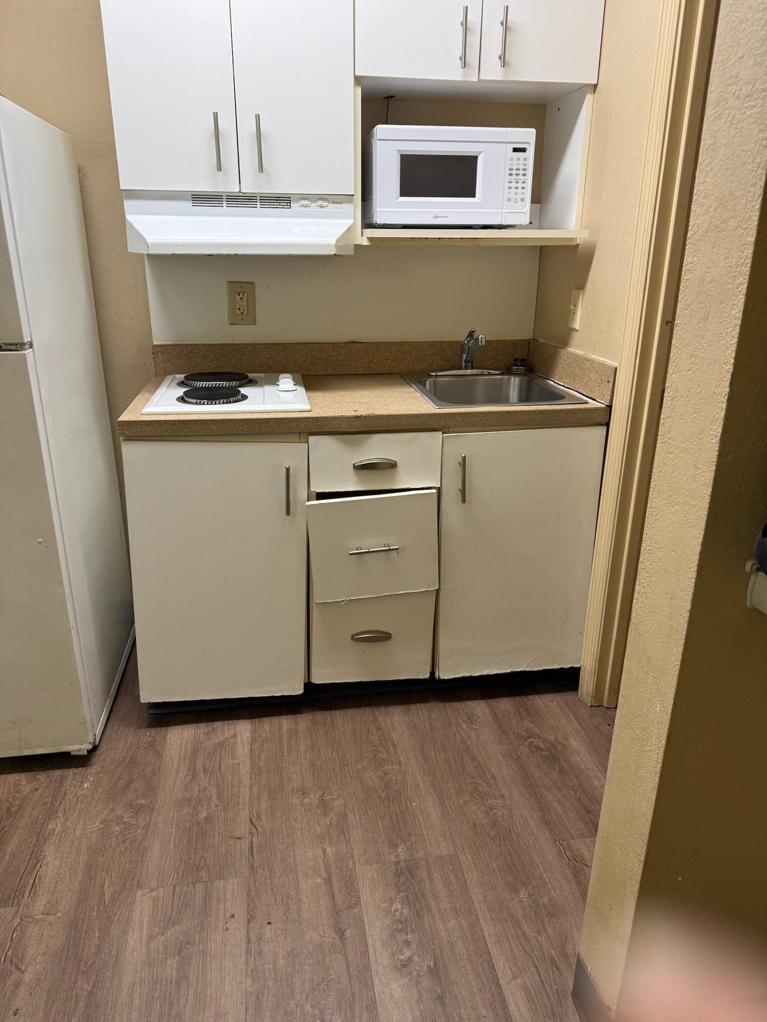 Broken caninetry; non-sanitized kitchen